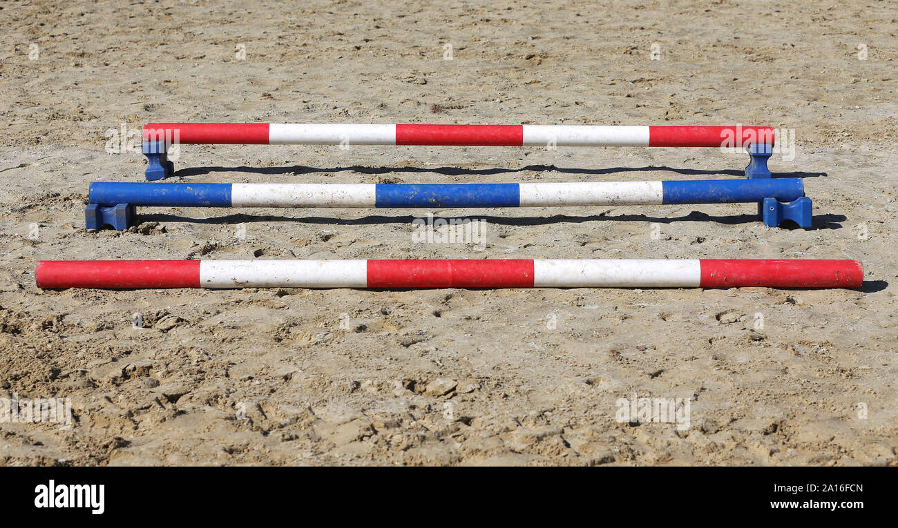 Colorful barriers on the ground for jumping horses and riders at riding ...