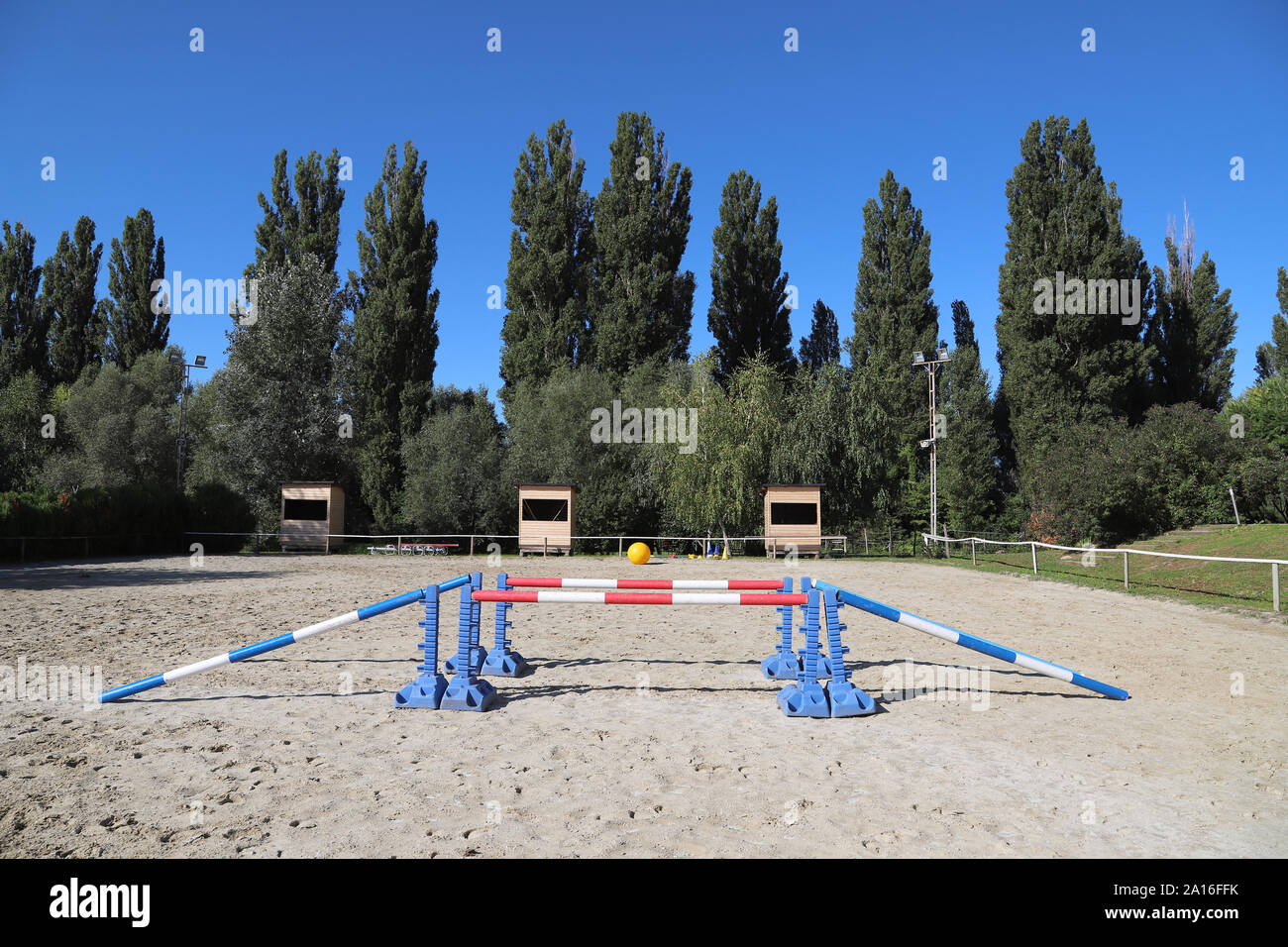 Colorful barriers on the ground for jumping horses and riders at riding ...