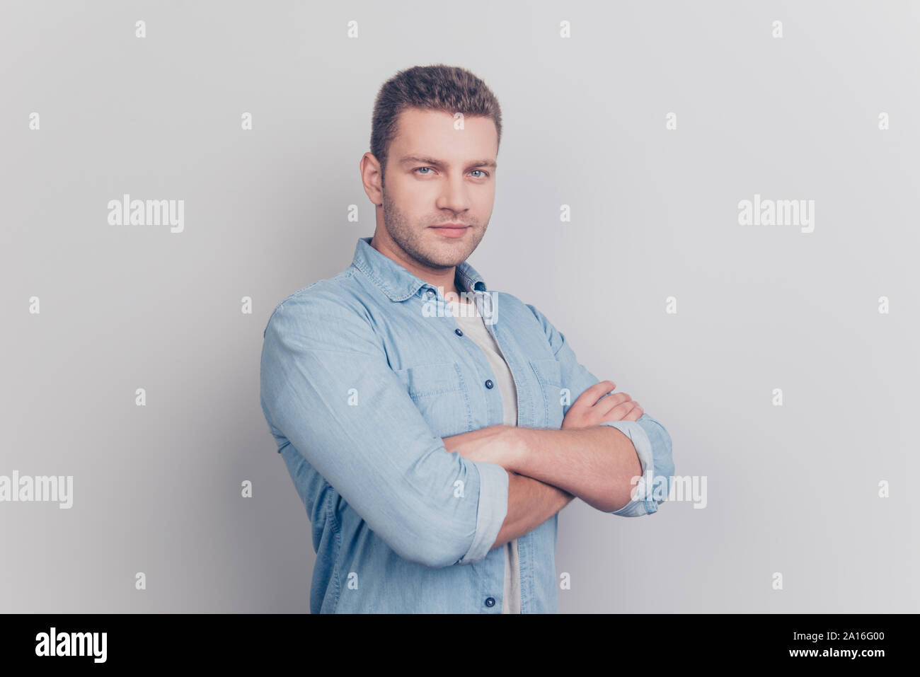 Photo of half turned man look at camera hold hands over chest st Stock ...
