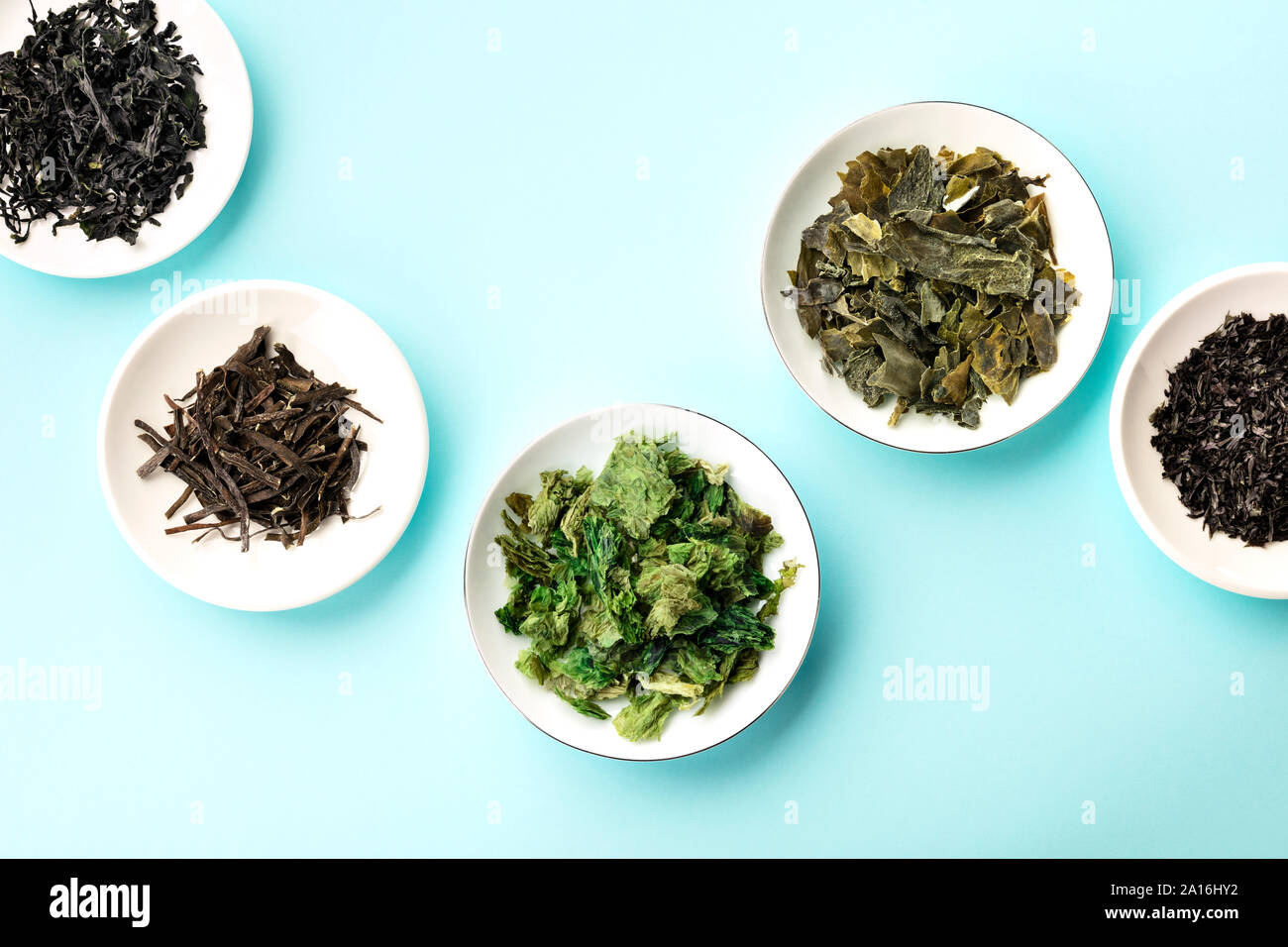 Various dry seaweed, sea vegetables, shot from above on a teal blue ...