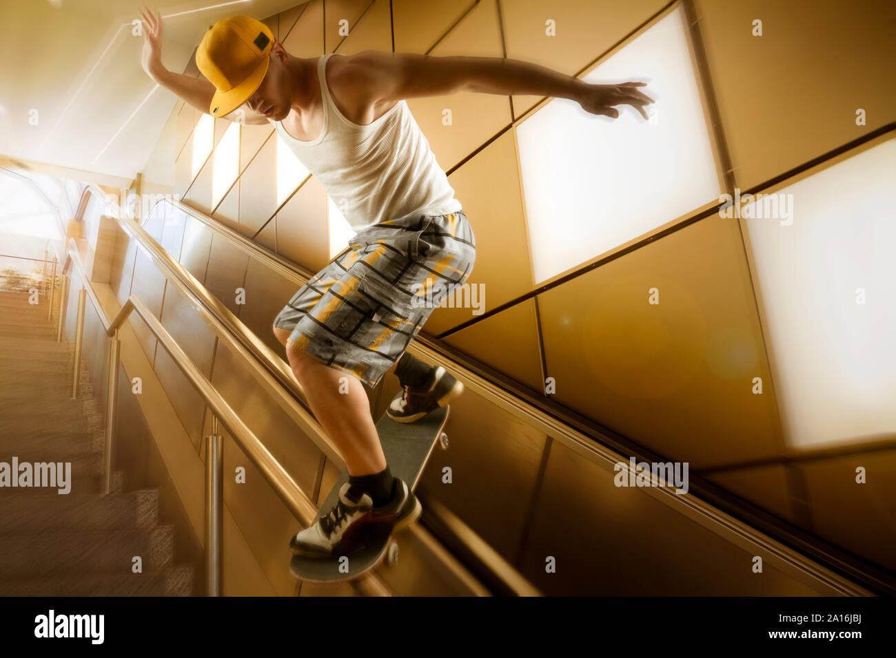 young skateboarder sliding down handrail Stock Photo - Alamy