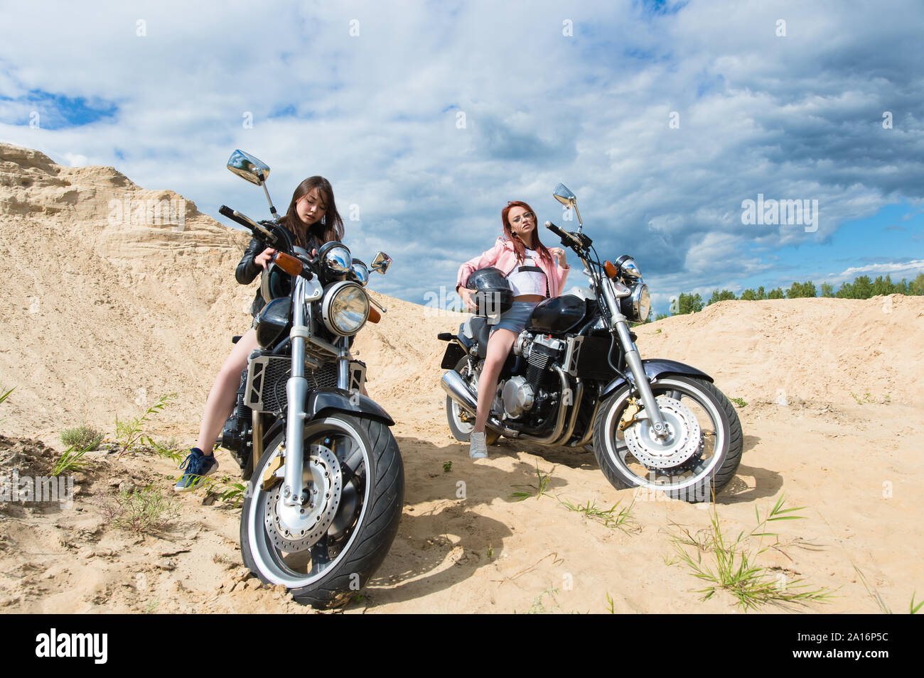 two beautiful girls on motorcycles Stock Photo - Alamy
