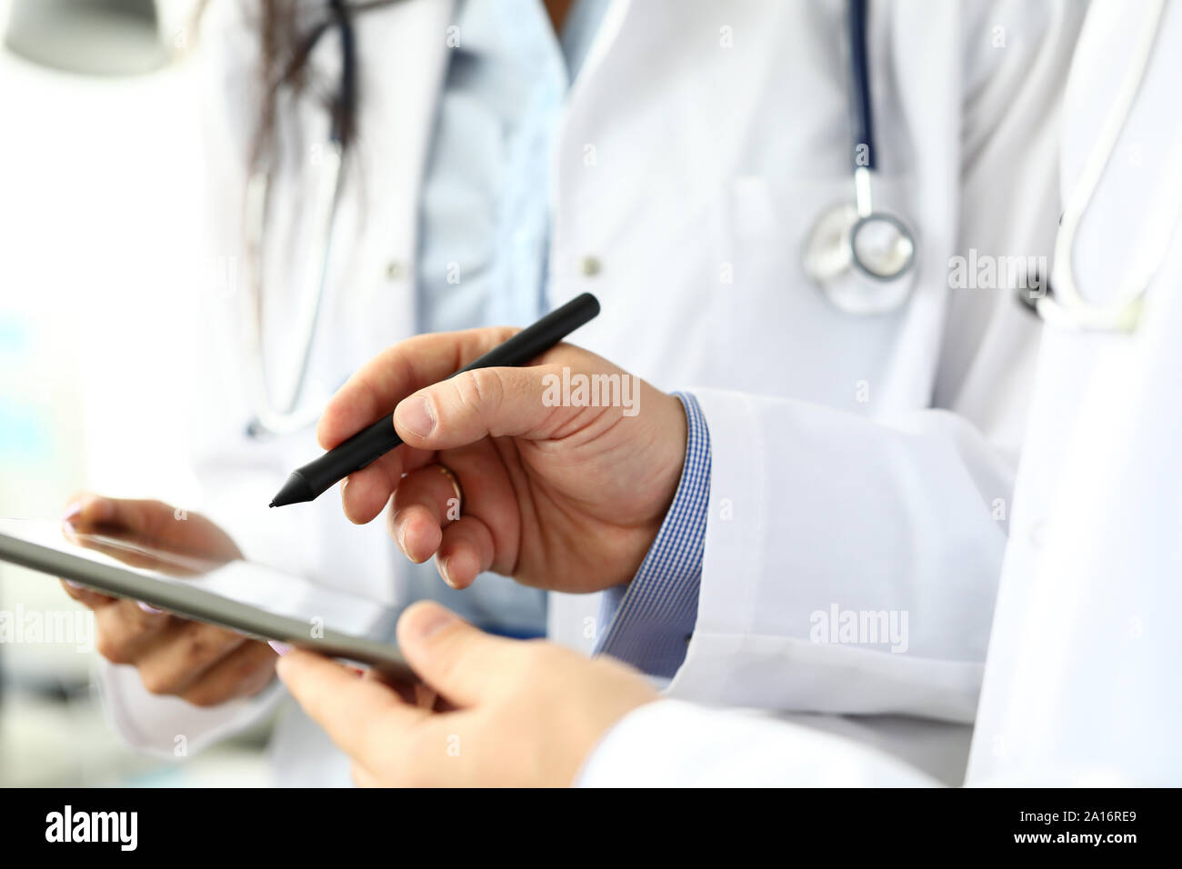 Male GP making electronic notes in tablet pc Stock Photo - Alamy