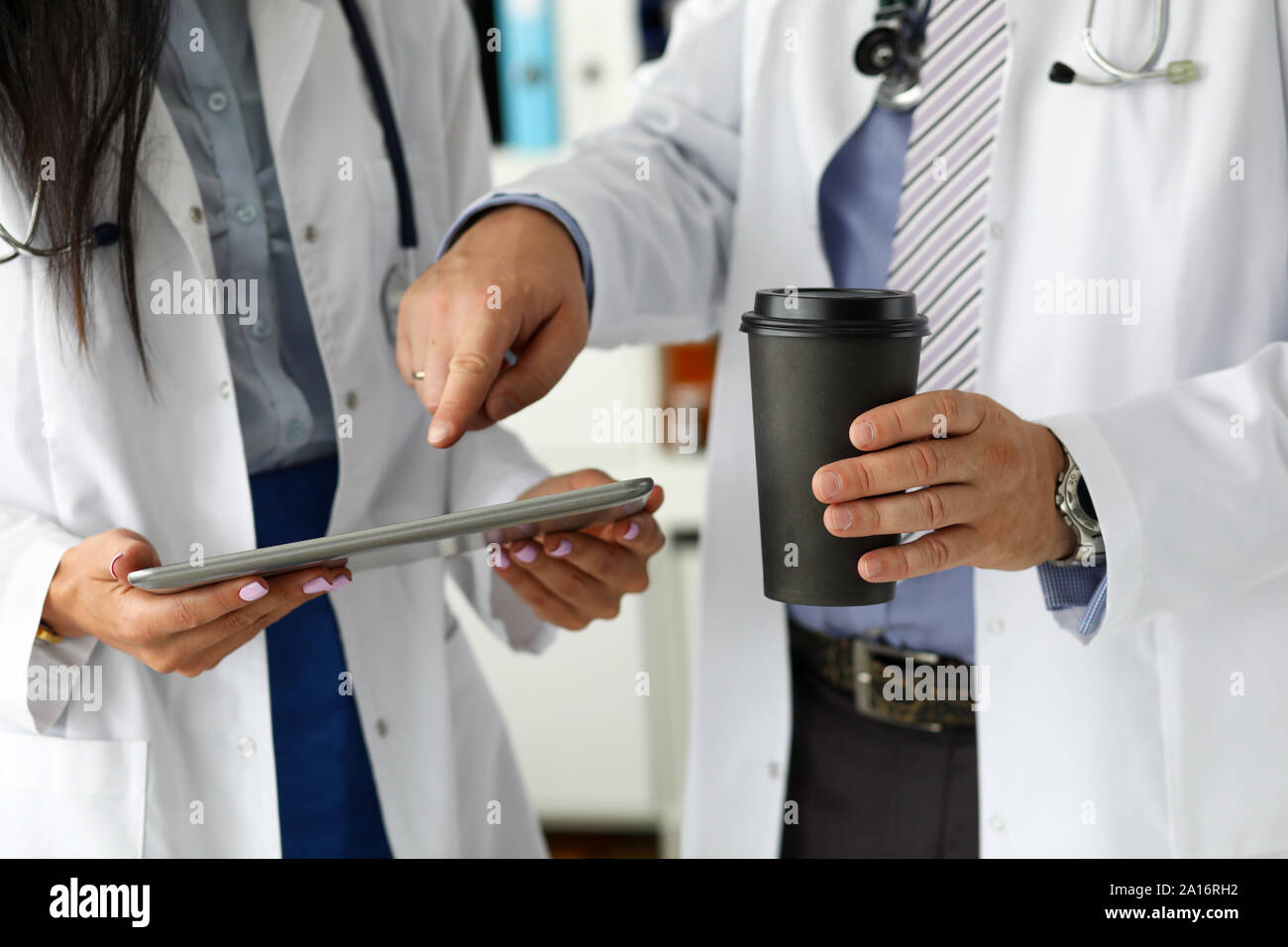 Two doctors looking in tablet pc display Stock Photo - Alamy