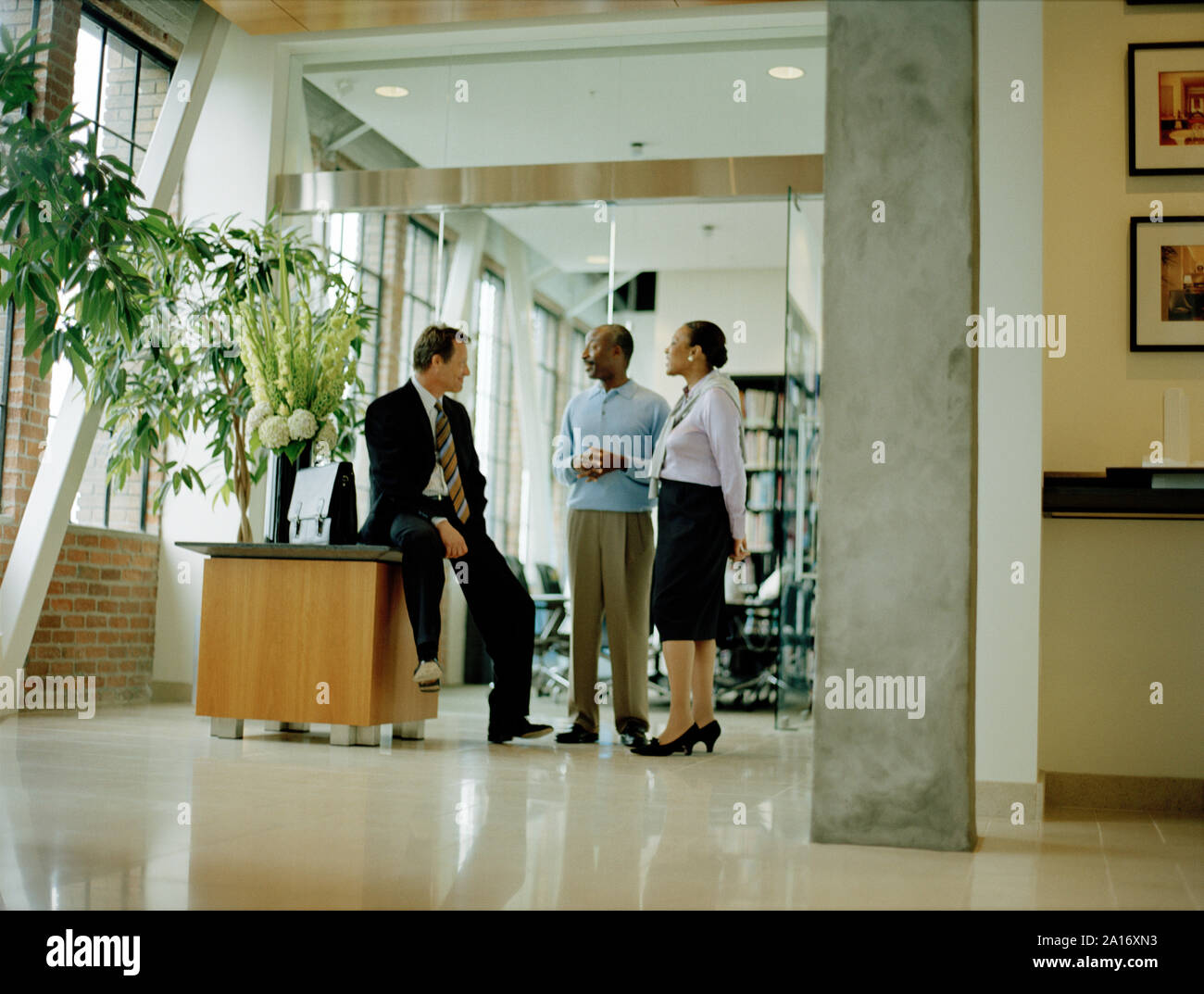 People in office talking Stock Photo - Alamy