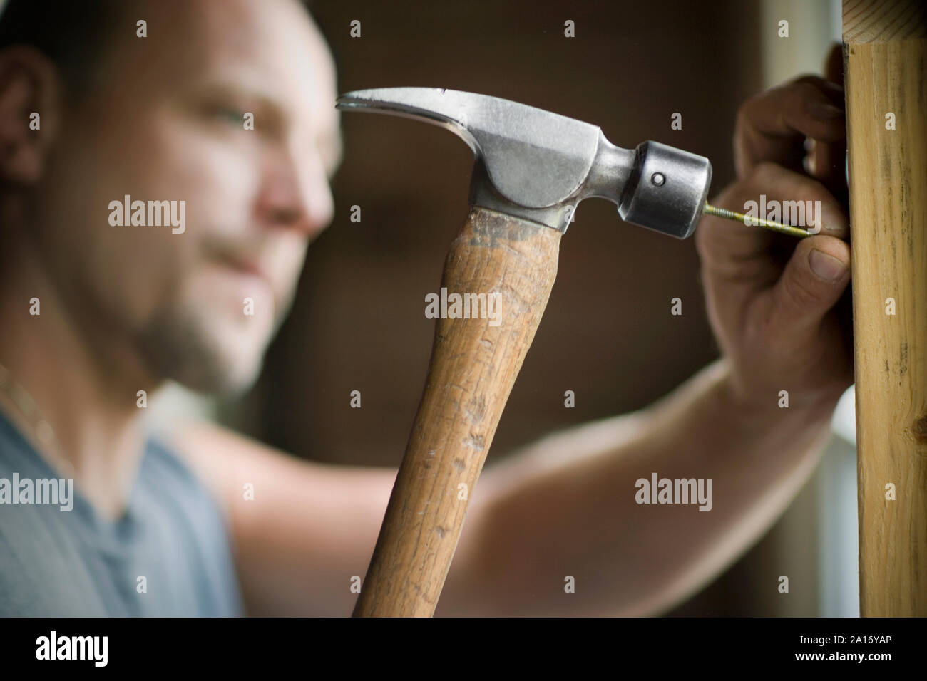 Mans hand holds hammer hi-res stock photography and images - Alamy
