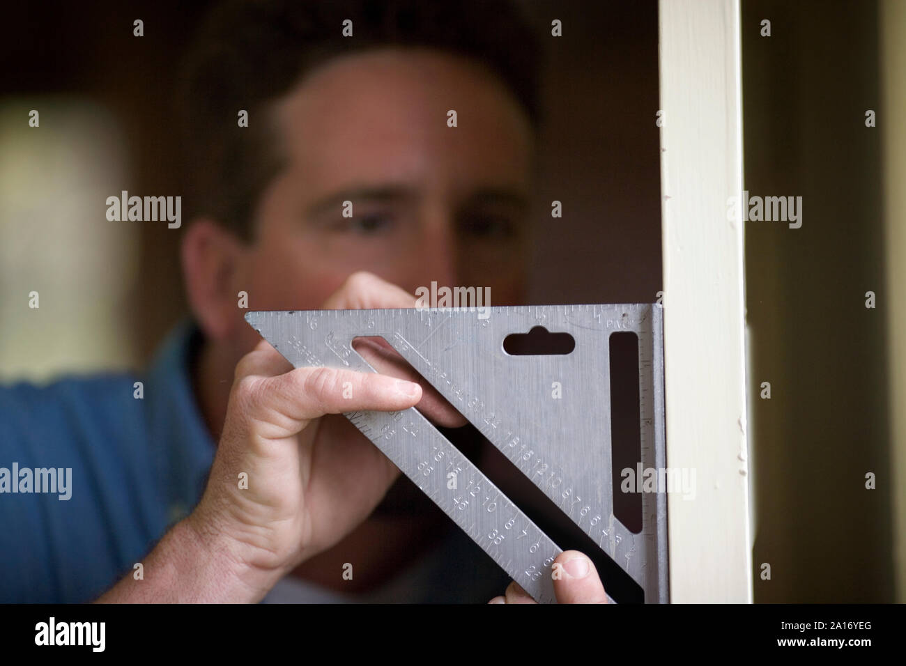 Male builder measuring a door Stock Photo - Alamy