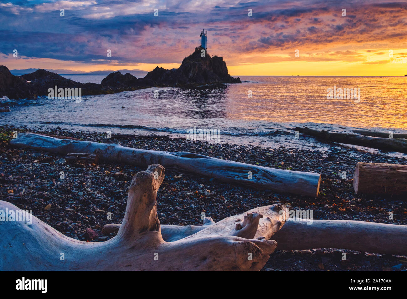 Rocky beach sunsets along the Pacific North West's Bowen Island in Howe Sound with spectacular ...