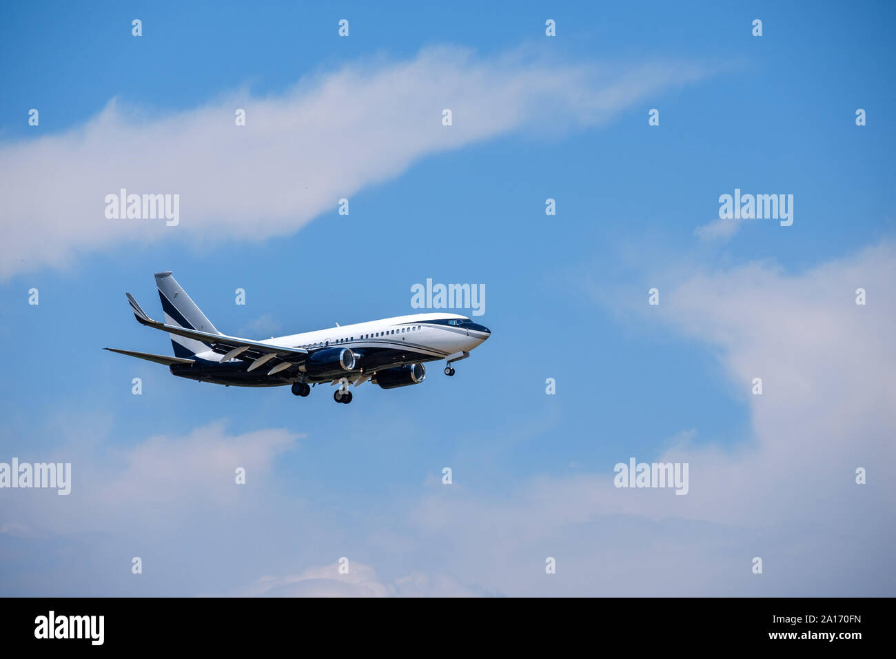 Passenger airplane flying in blue sky, side view Stock Photo - Alamy