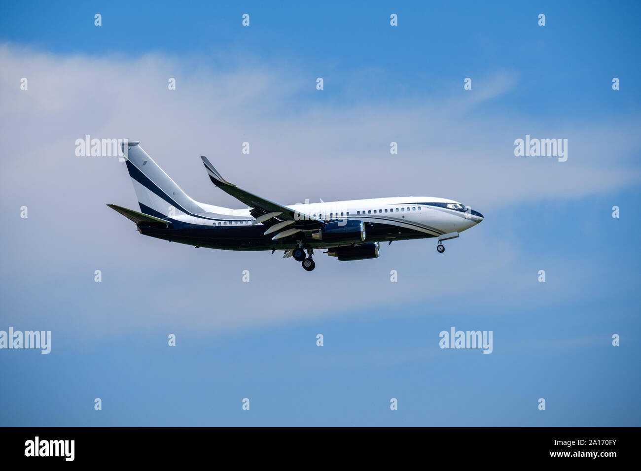Passenger airplane flying in blue sky, side view Stock Photo - Alamy
