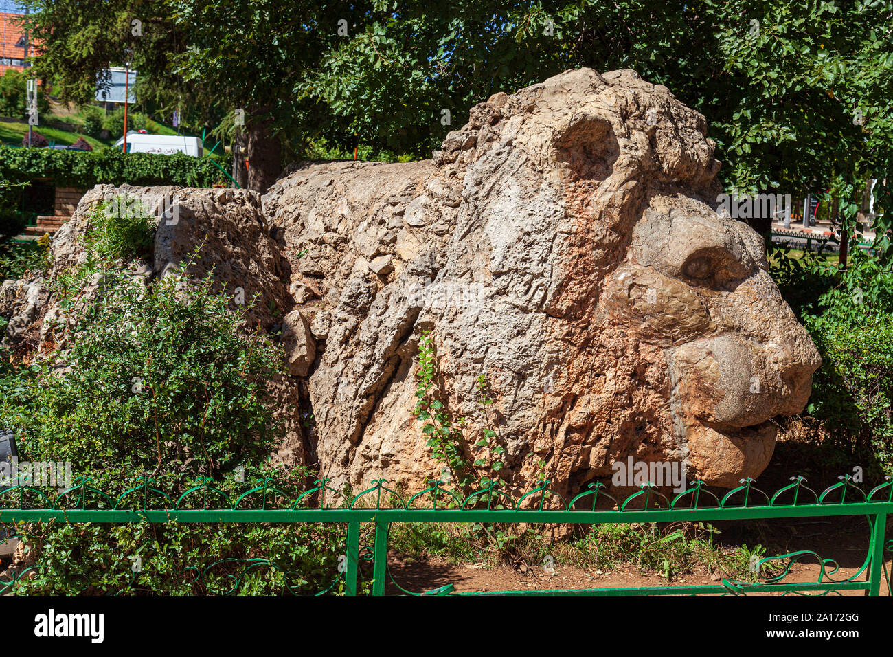 Ifrane's cult landmark is the stone lion that sits on a patch of grass ...