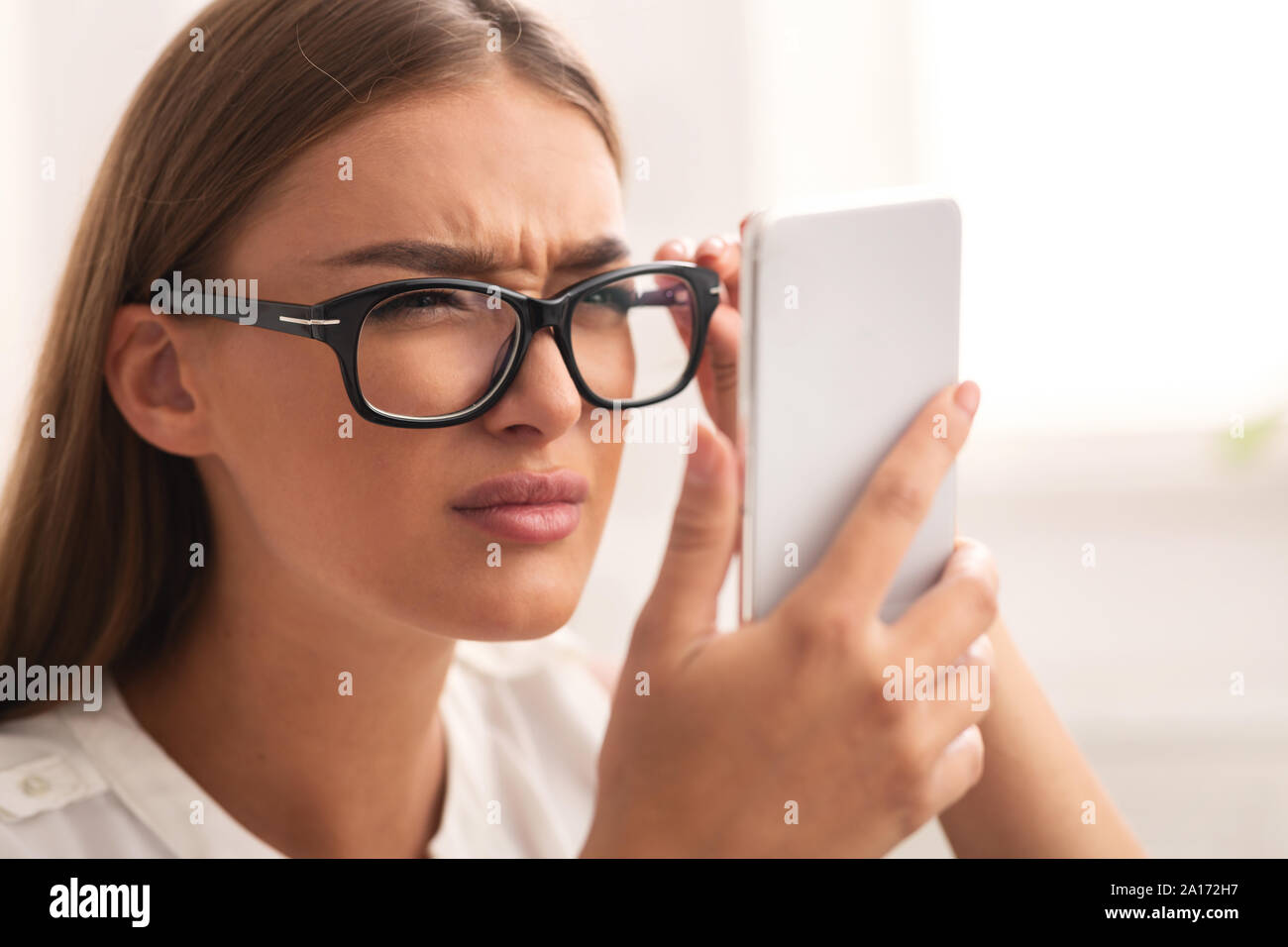 Girl Looking At Cellphone Through Eyeglasses Having Vision Problem ...