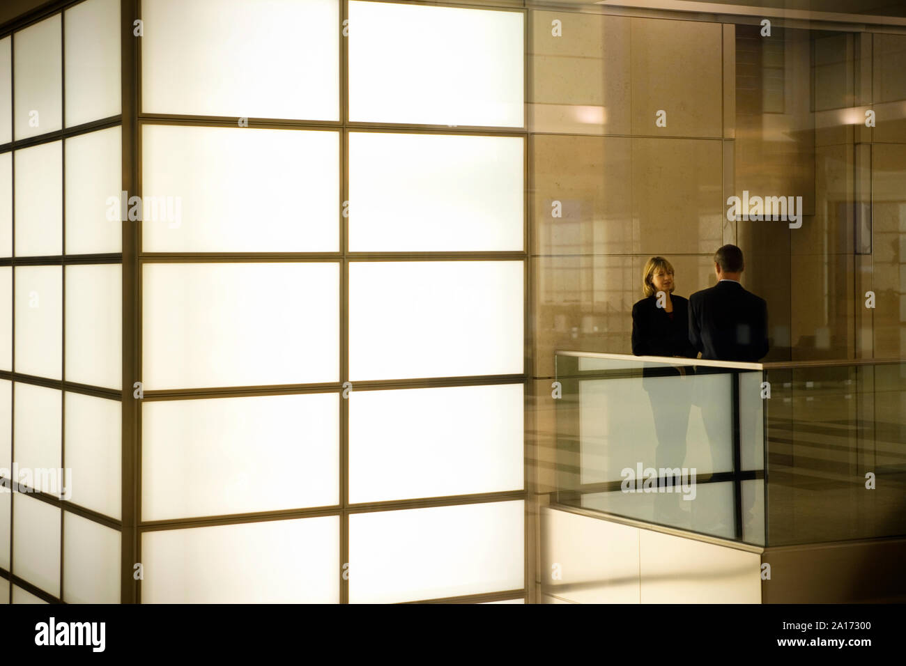 Mid-adult business people talking inside a building Stock Photo - Alamy