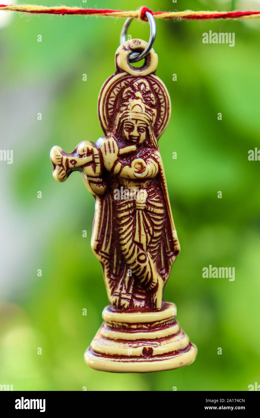 Yellow colour lord krishna with flute idol in green beautiful ...