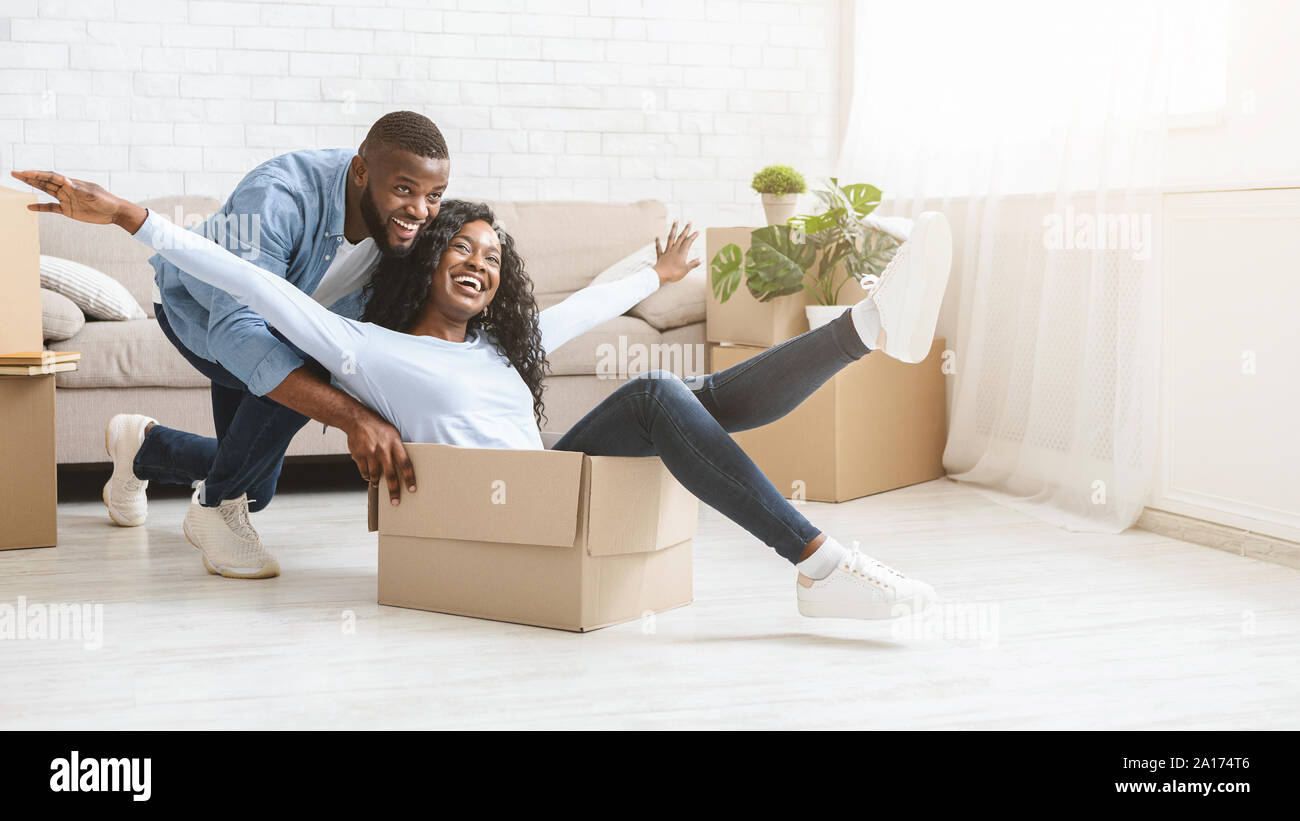 Joyful couple with unpacking boxes hi-res stock photography and images ...