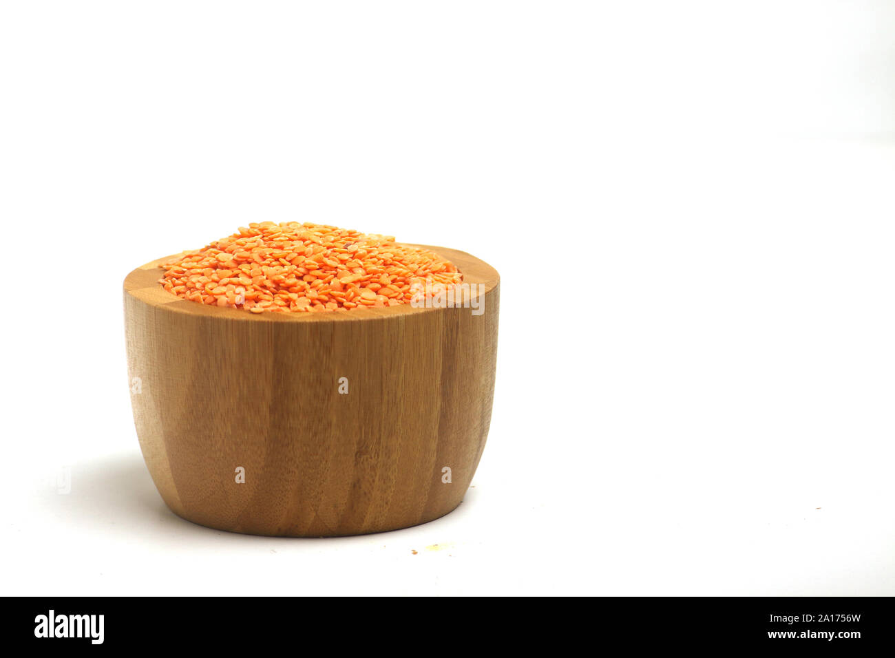 red lentils in a wooden bowl isolated on white background Stock Photo ...