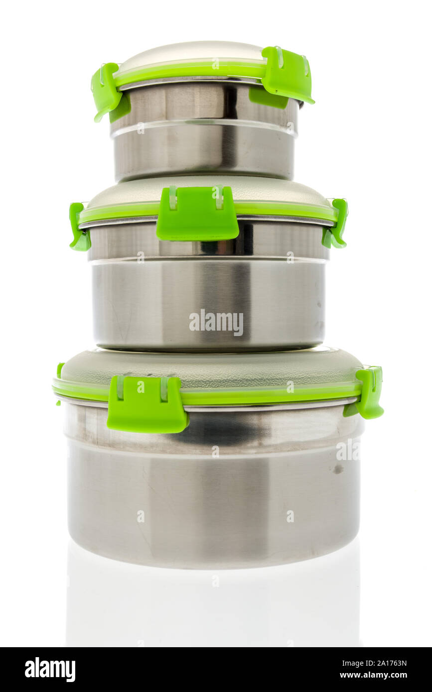 A collection of round stainless steel containers used for food storage ...