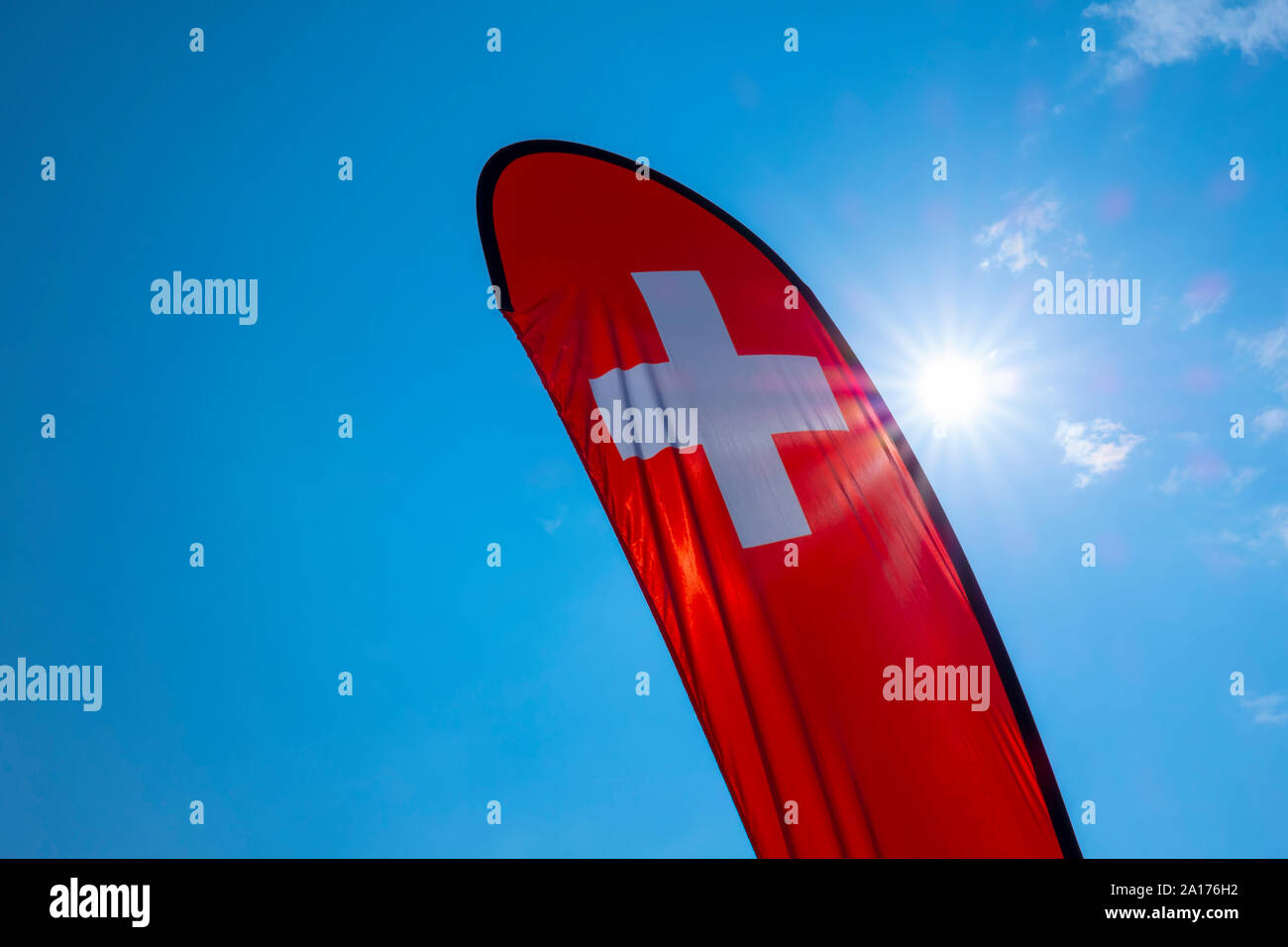 Swiss Banner Flag Against Blue Sky and Sun in Switzerland Stock Photo ...
