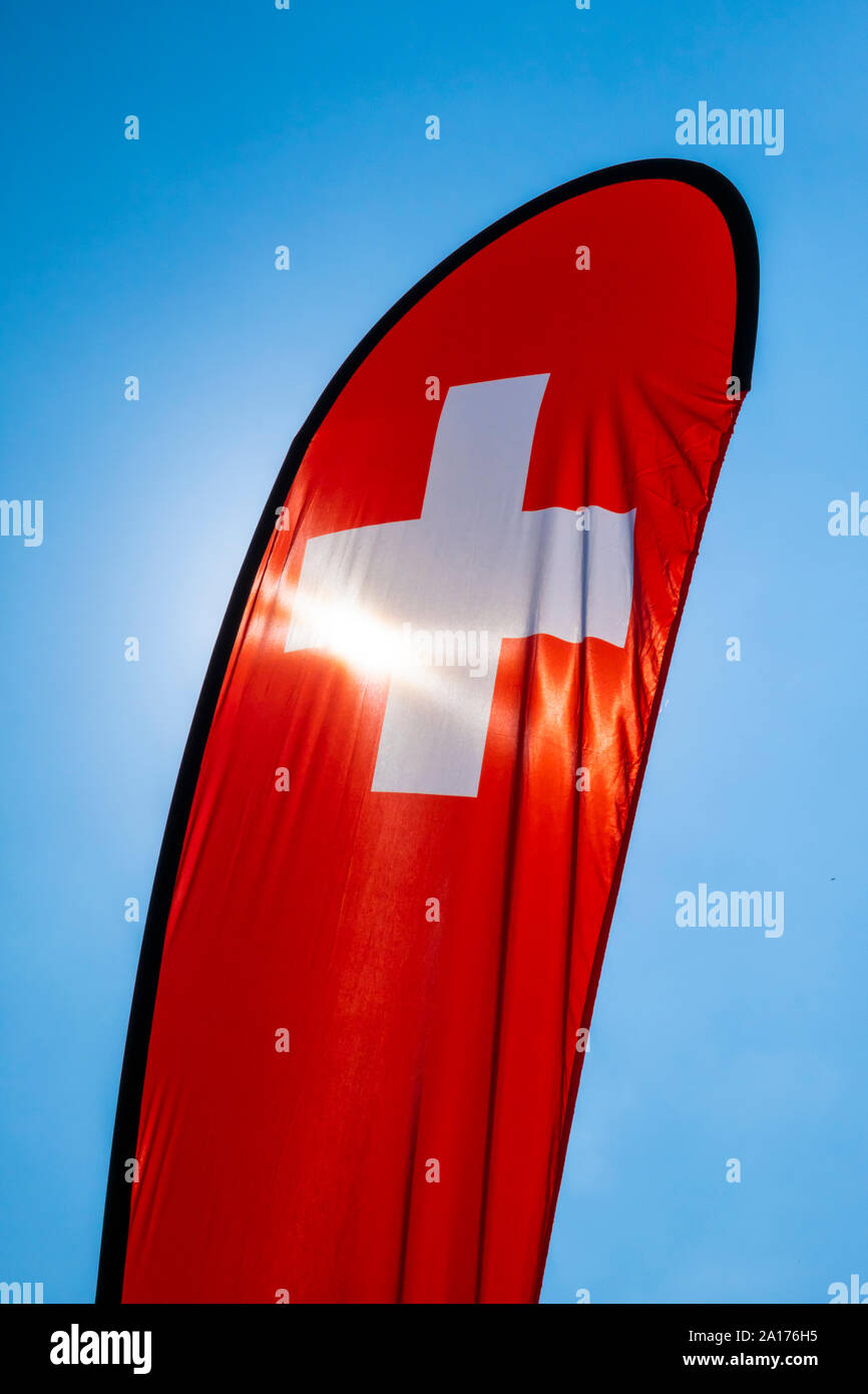 Swiss Banner Flag Against Blue Sky and Sun in Switzerland Stock Photo ...