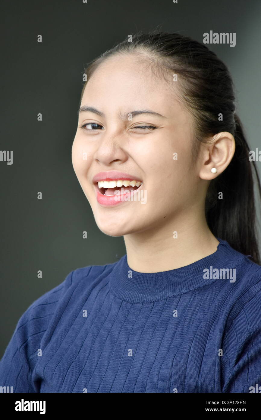 A Beautiful Diverse Teenage Female Winking Stock Photo - Alamy