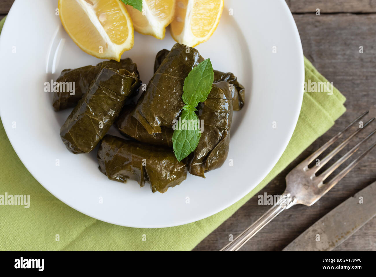 Grape leaf filled with rice served with lemon. Traditional Greek food ...