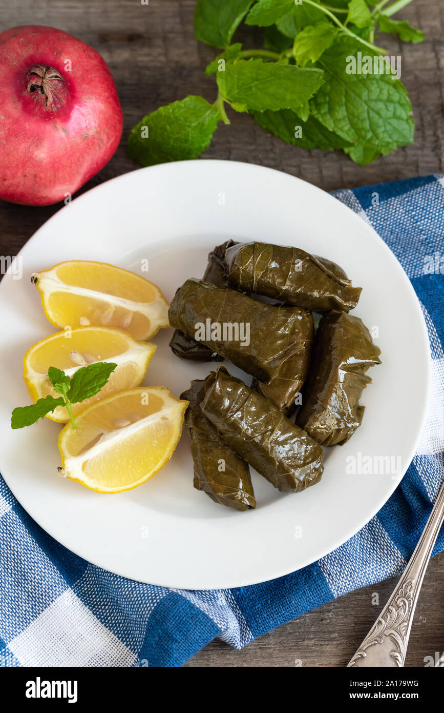 Grape leaf filled with rice served with lemon. Traditional Greek food ...