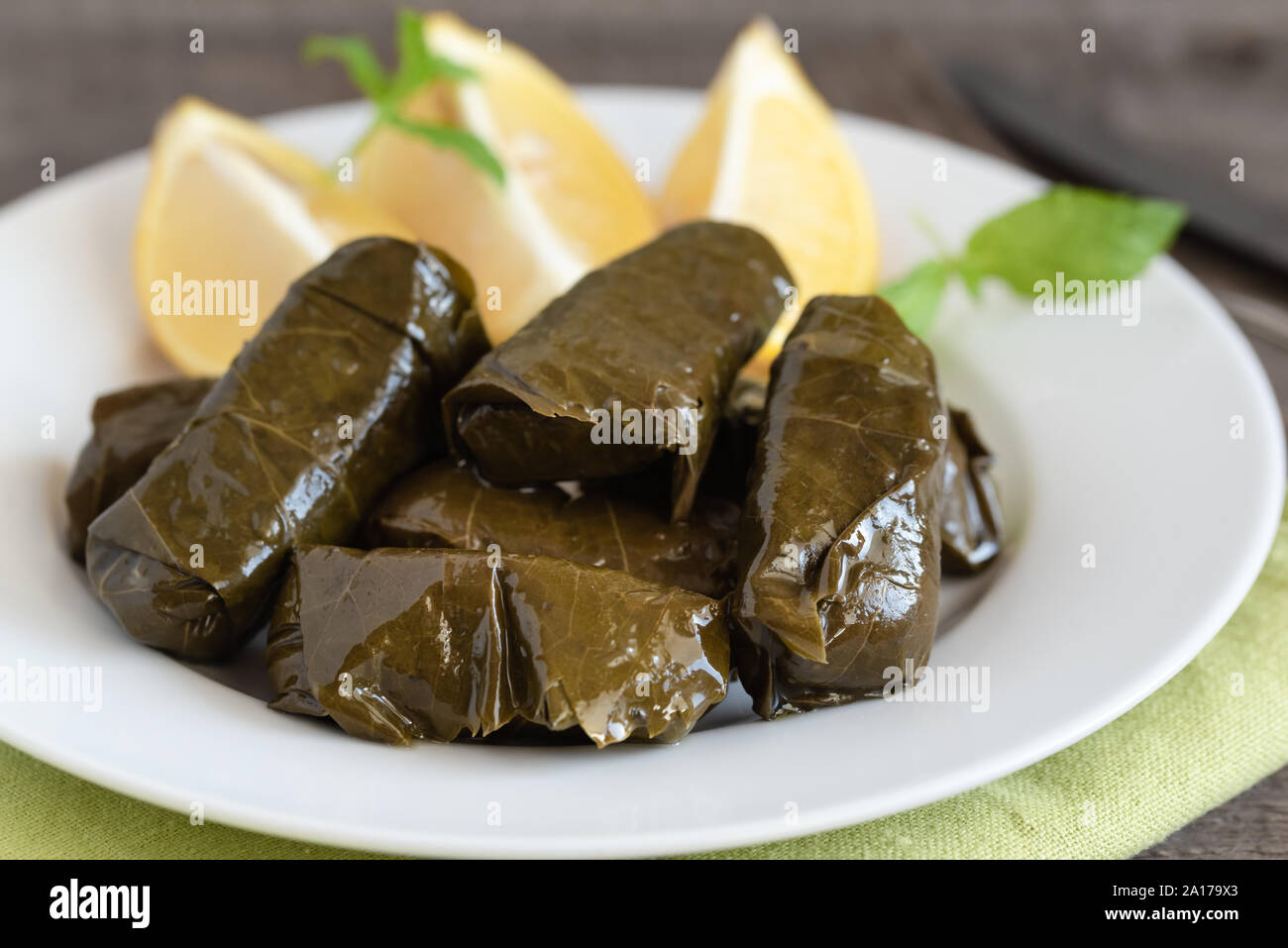 Grape leaf filled with rice served with lemon. Traditional Greek food ...