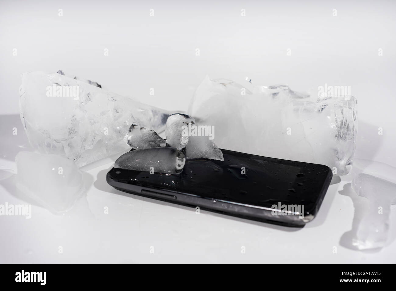 Black smartphone frozen in ice. Abstract object photo Stock Photo - Alamy