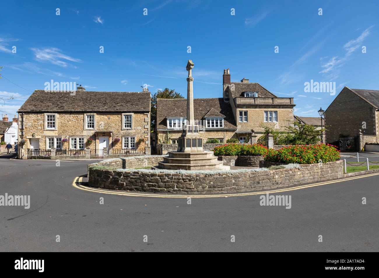 Melksham War Memorial with traditional stone built cottages in the ...
