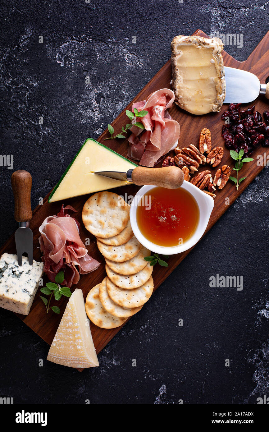 Cheese and snack board with crackers and prosciutto Stock Photo - Alamy