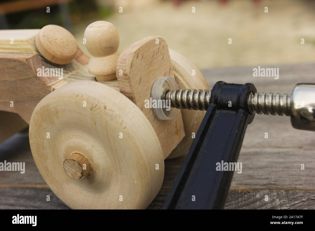 Handmade wooden toy for boy. Gluing process. Clamped by clamp Stock ...