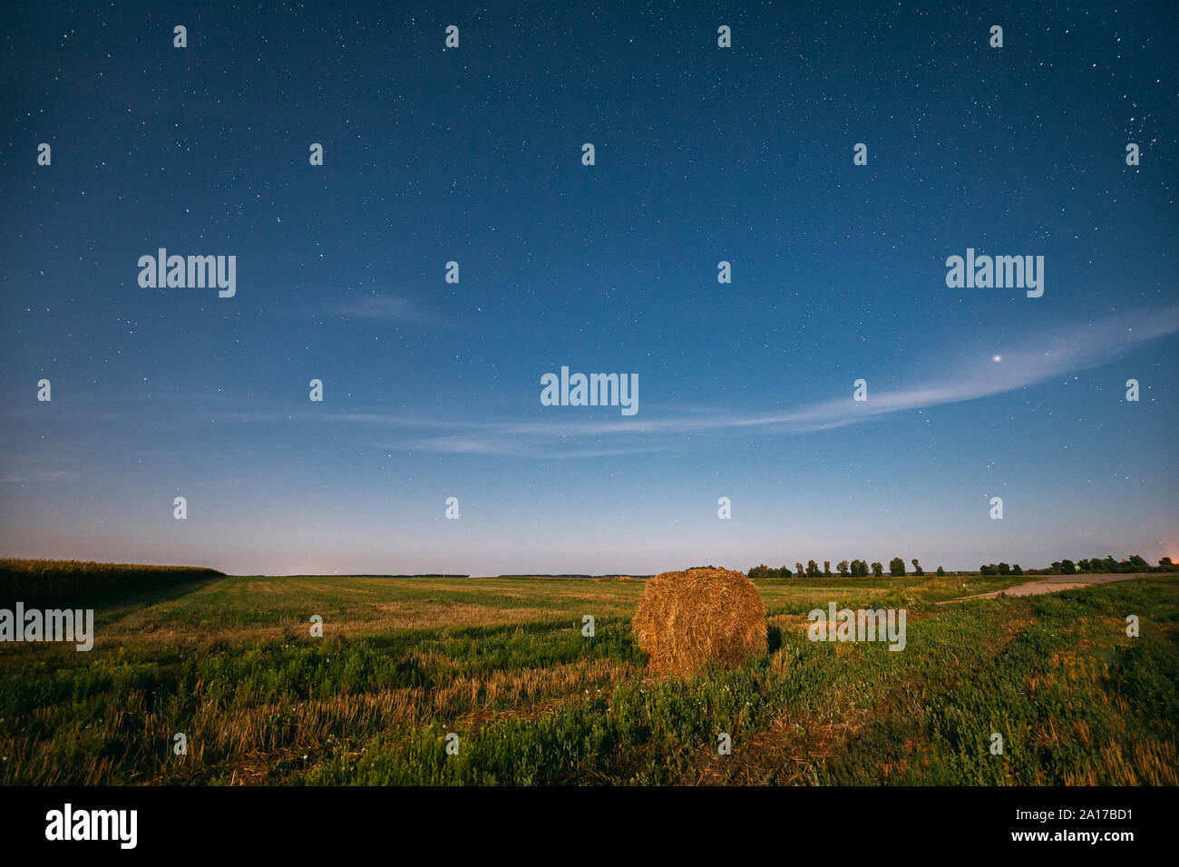 Natural Night Starry Sky Above Field Meadow With Hay Bale After Harvest ...