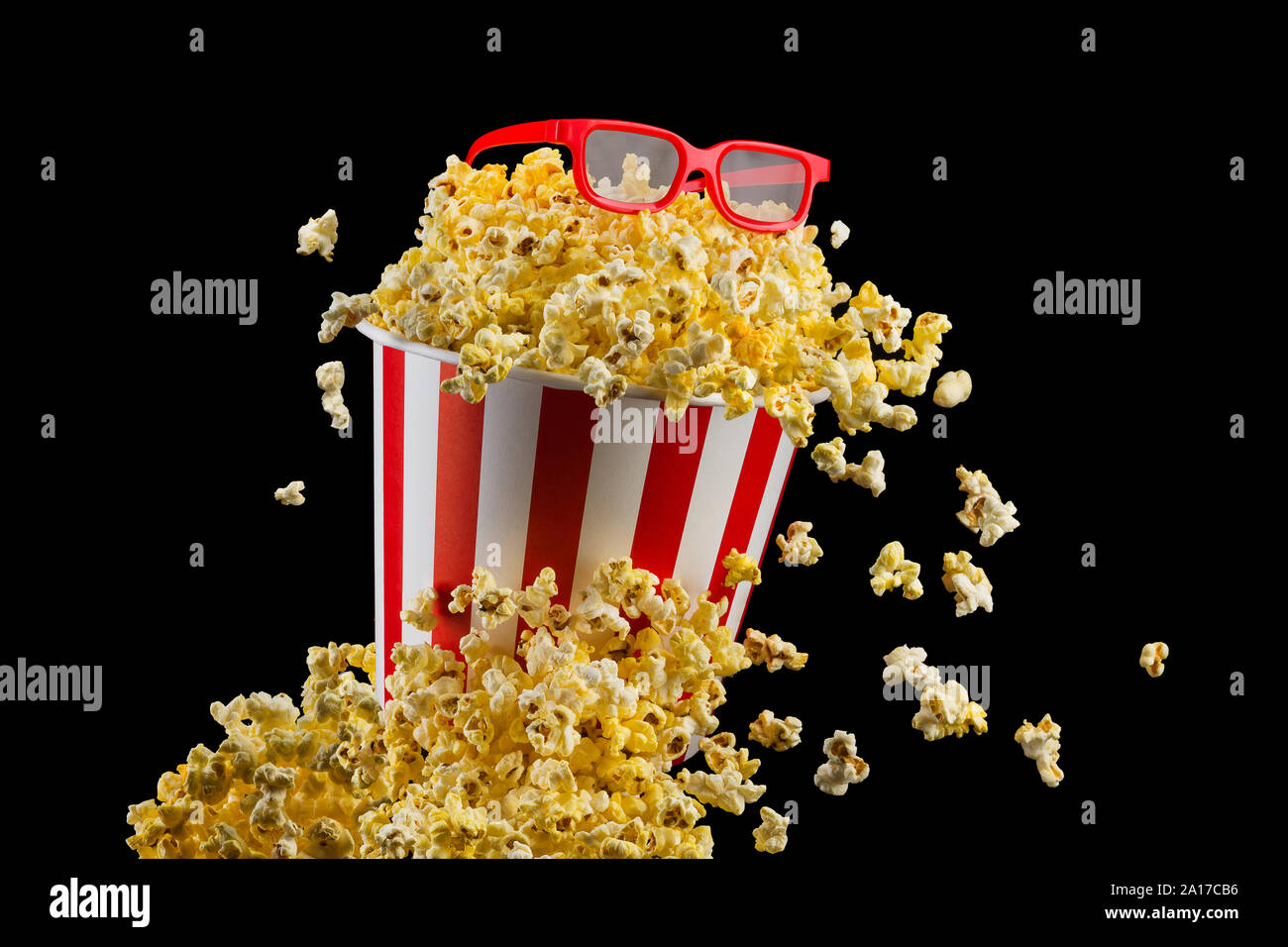 Flying popcorn from striped bucket isolated on black background Stock ...
