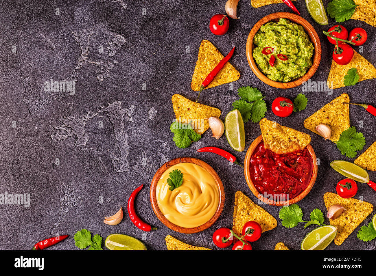 Mexican food background: guacamole, salsa, cheesy sauces with ...