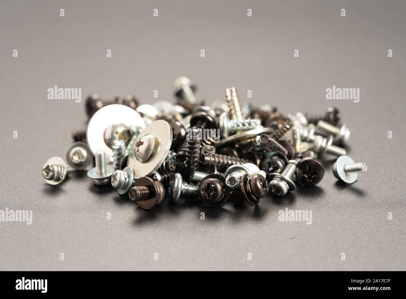 Screws and bolts fasteners industrial black background Stock Photo - Alamy