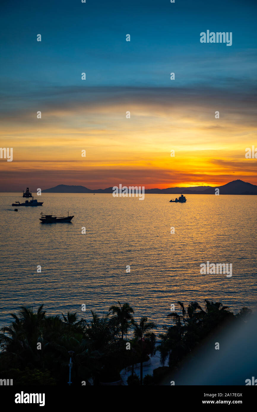 Fishing boats on sea in sunset lights in Sanya, Hainan, China Stock ...