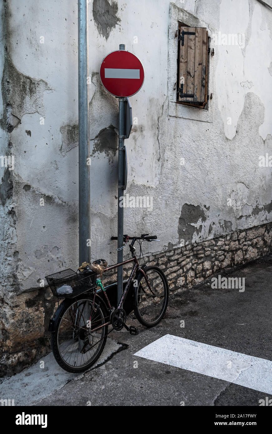 Old Bicycle Locked With Chain On Pole In Front Of Old House Stock Photo ...