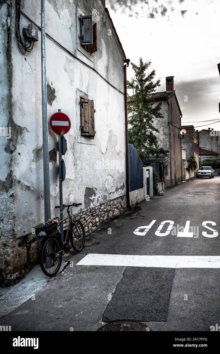 Old Bicycle Locked With Chain On Pole In Front Of Old House Stock Photo ...