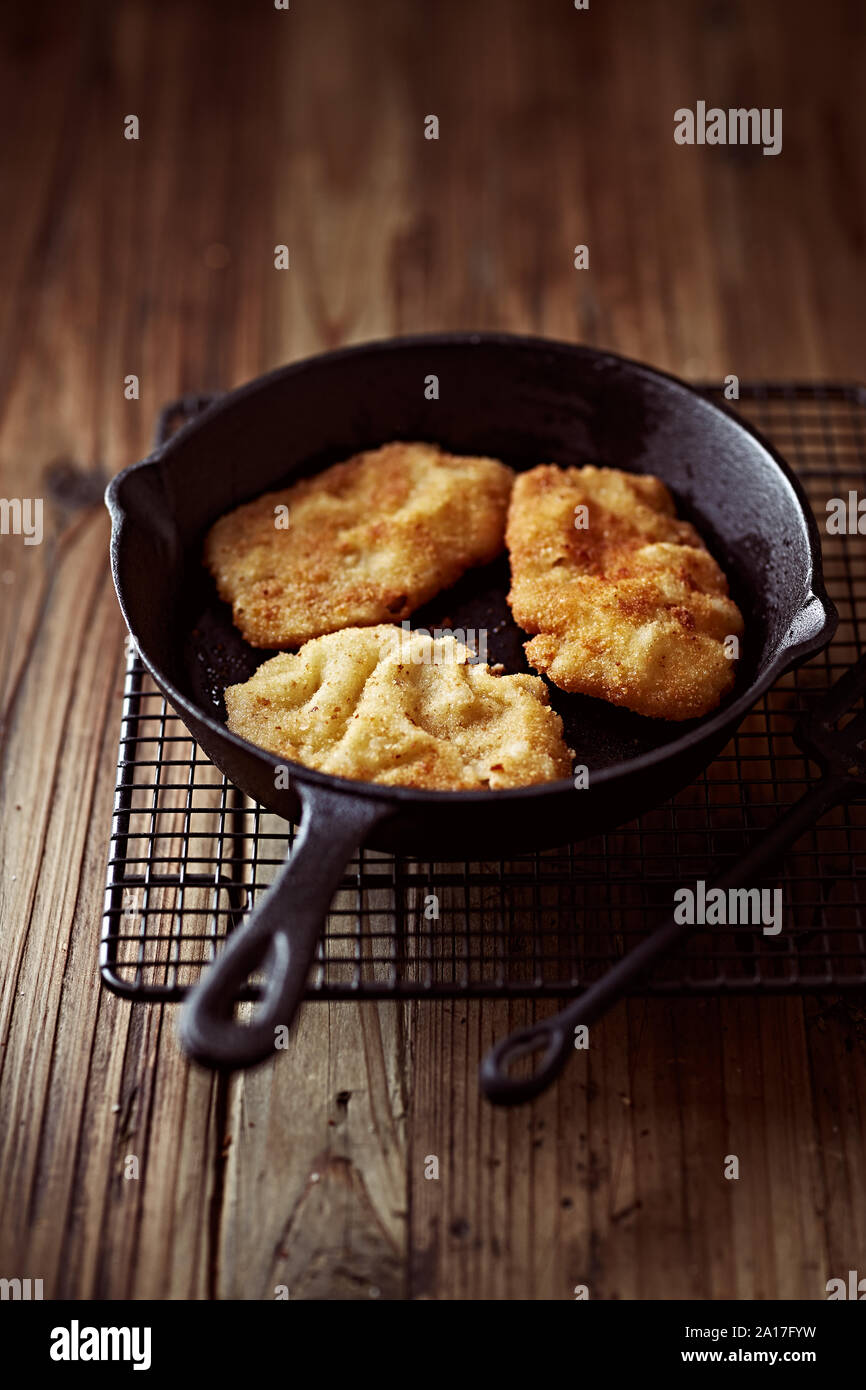 Wiener schnitzel on a cast iron pan Stock Photo - Alamy