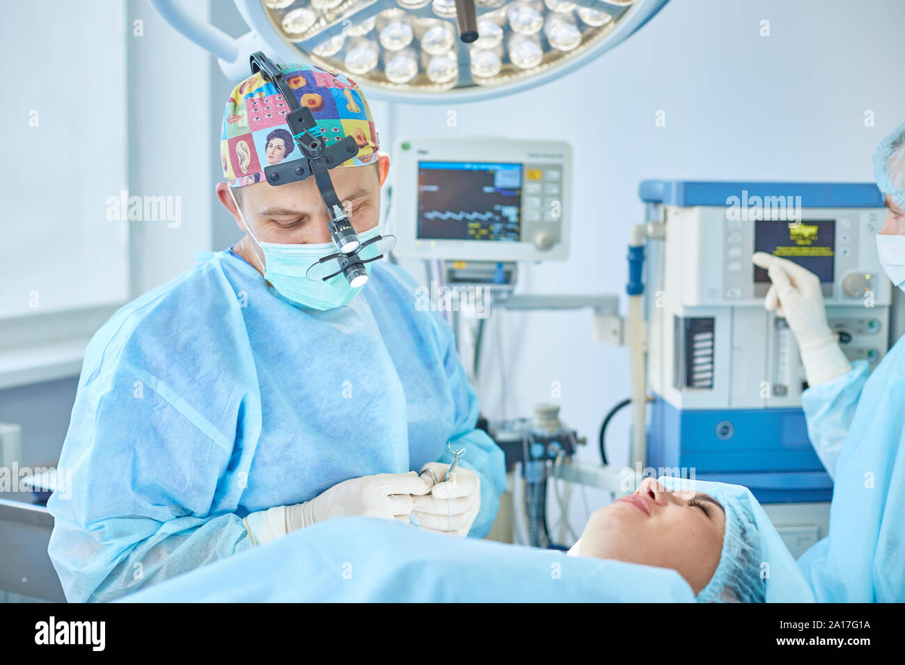 Several doctors surrounding patient on operation table during their ...