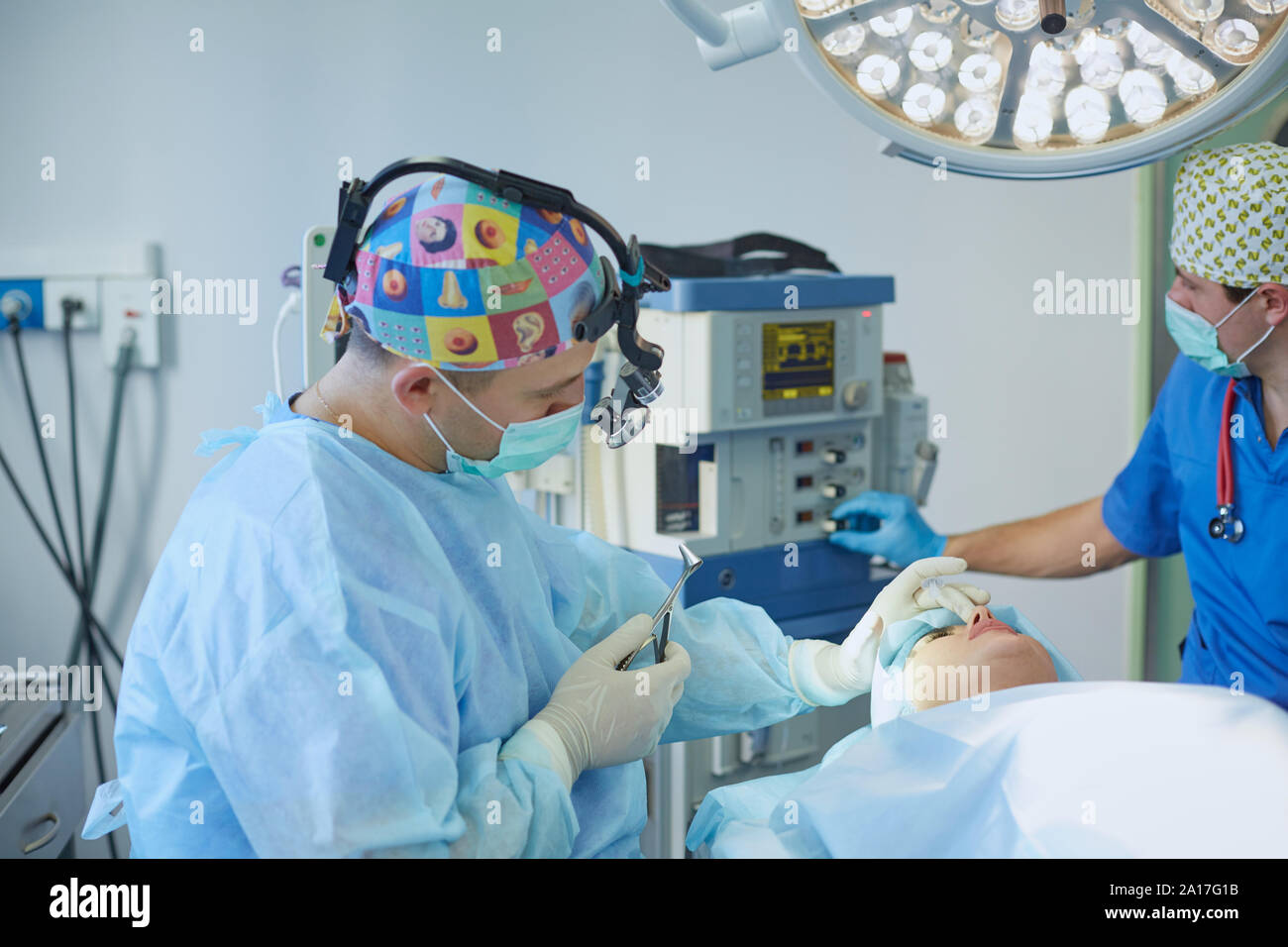 Several doctors surrounding patient on operation table during their ...