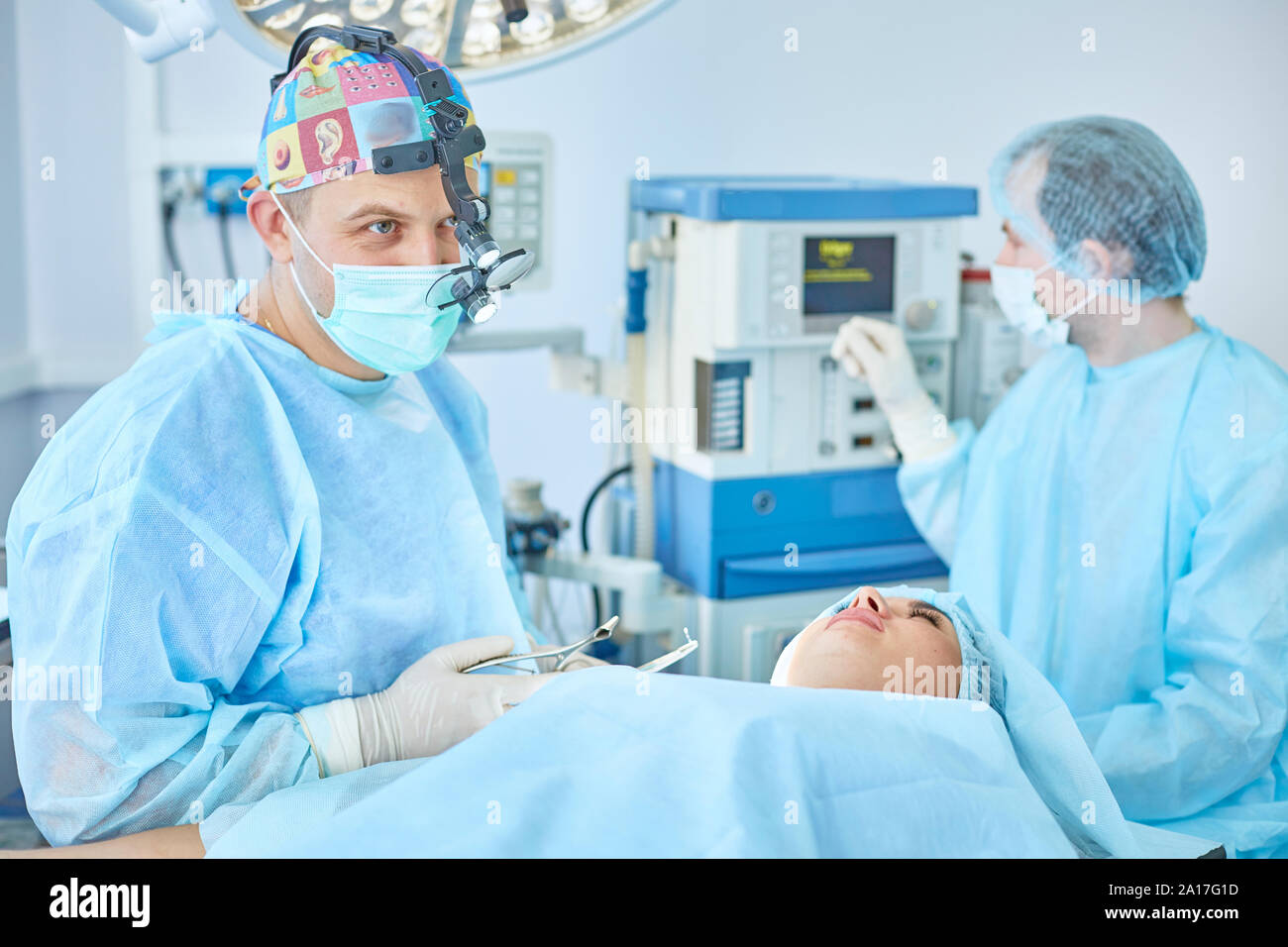 Several doctors surrounding patient on operation table during their ...