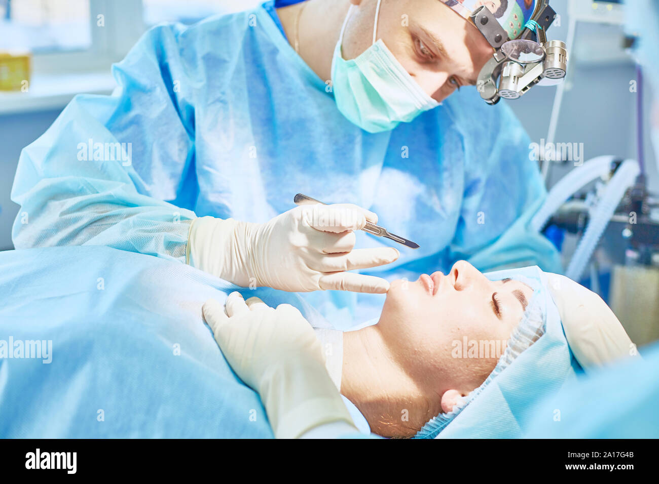Several doctors surrounding patient on operation table during their ...