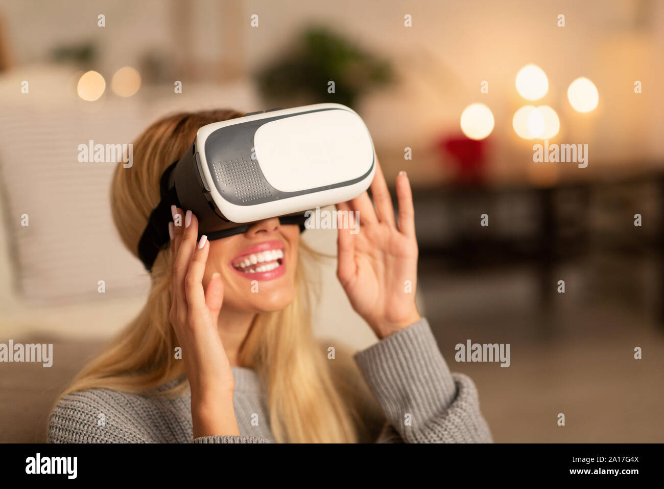 Girl using vr headset sitting hi-res stock photography and images - Alamy