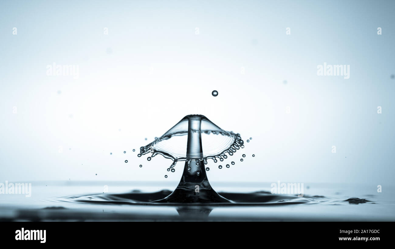 Close-up of a water drop falling on water surface Stock Photo - Alamy