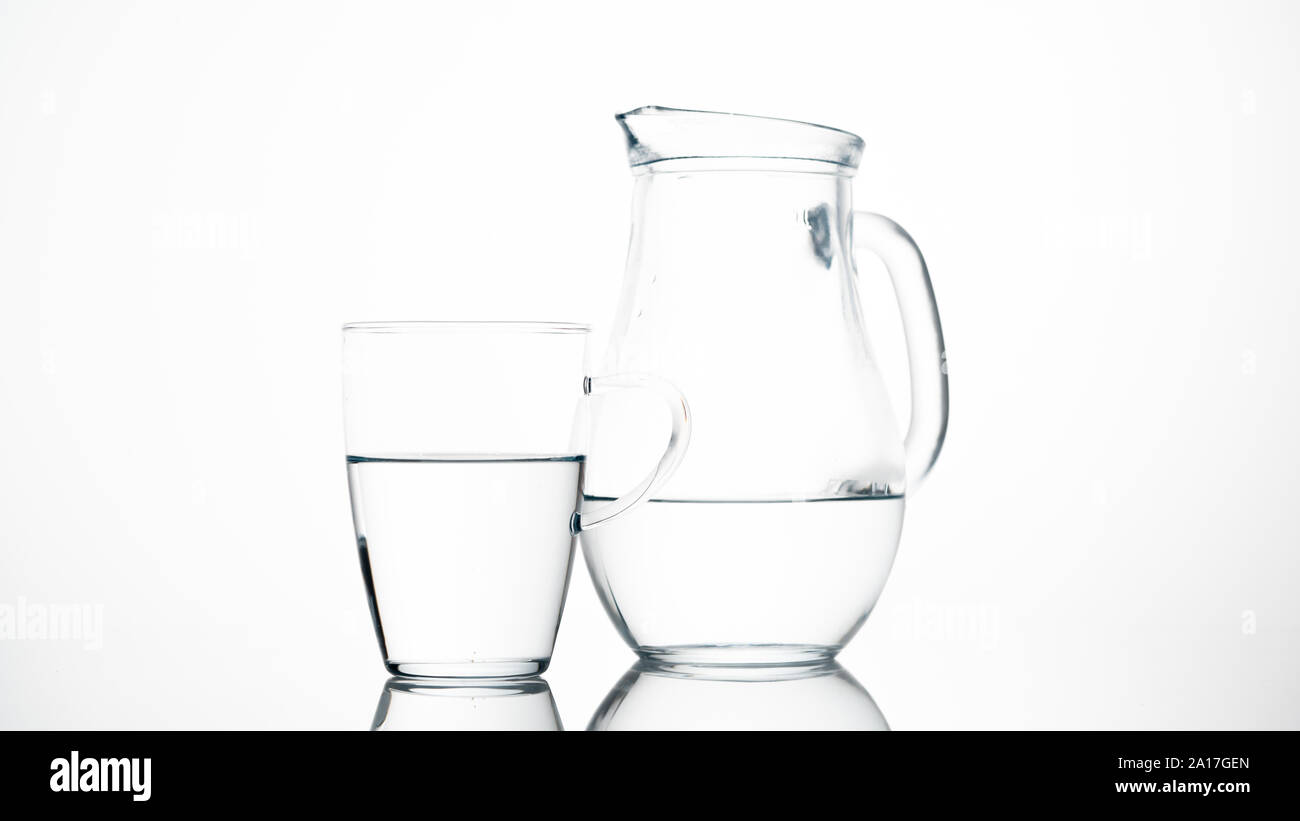 jar and glass of water on white background Stock Photo - Alamy