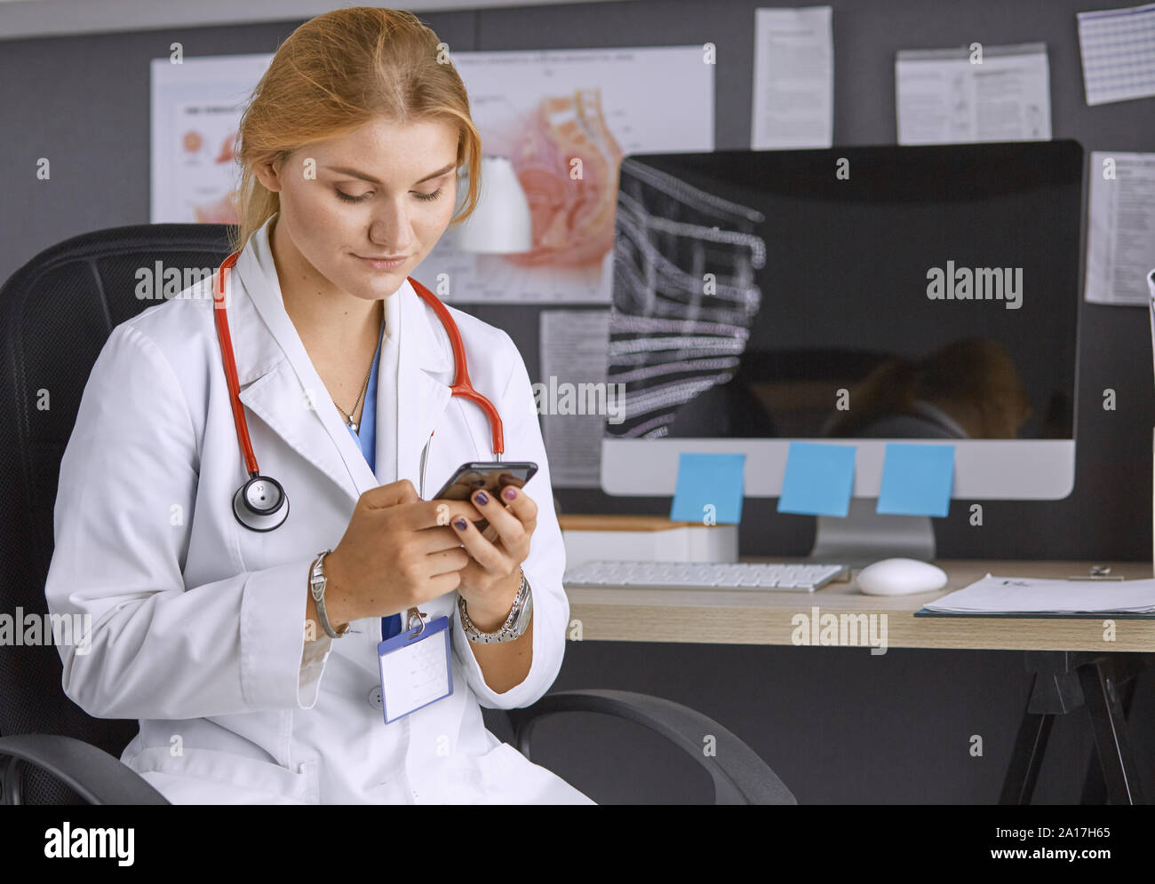 female doctor between patients in the office talking on the phone Stock ...