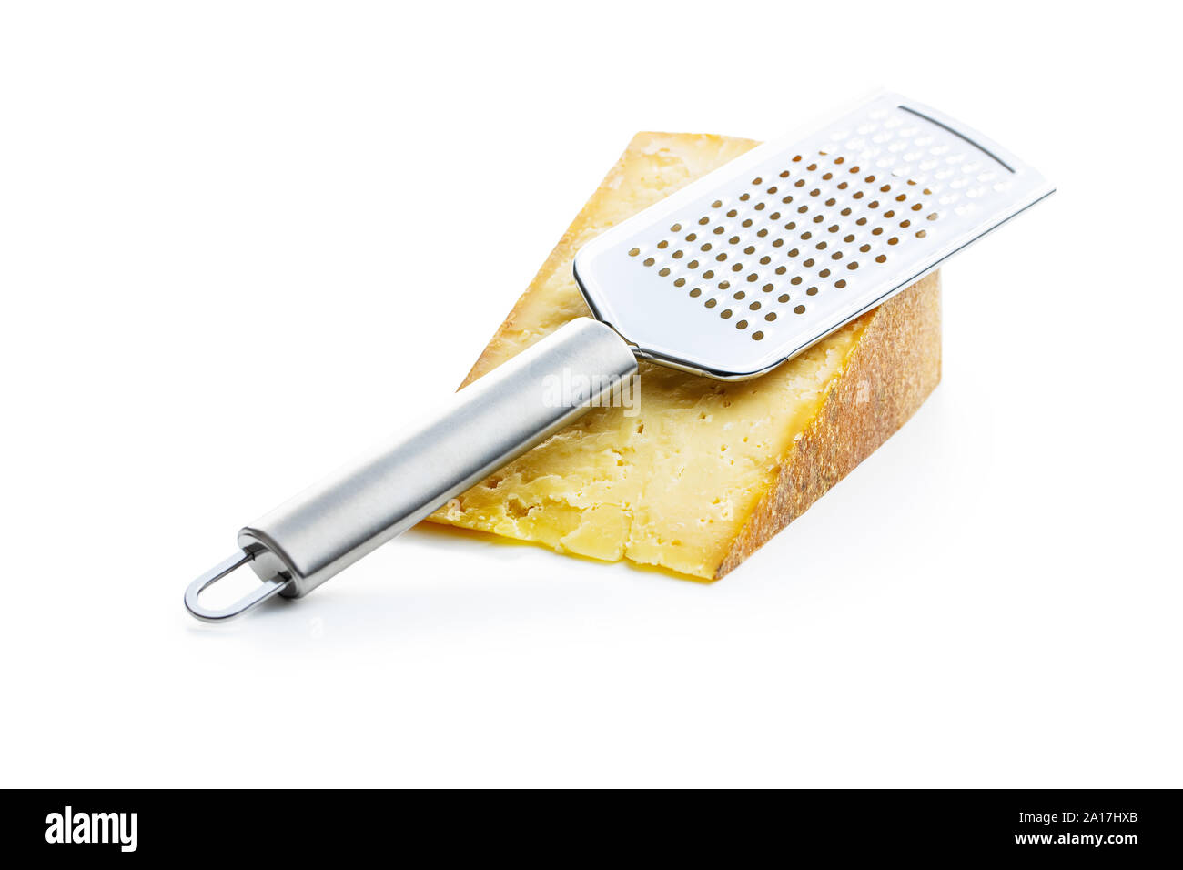 Tasty cheese block and cheese grater isolated on white background Stock ...