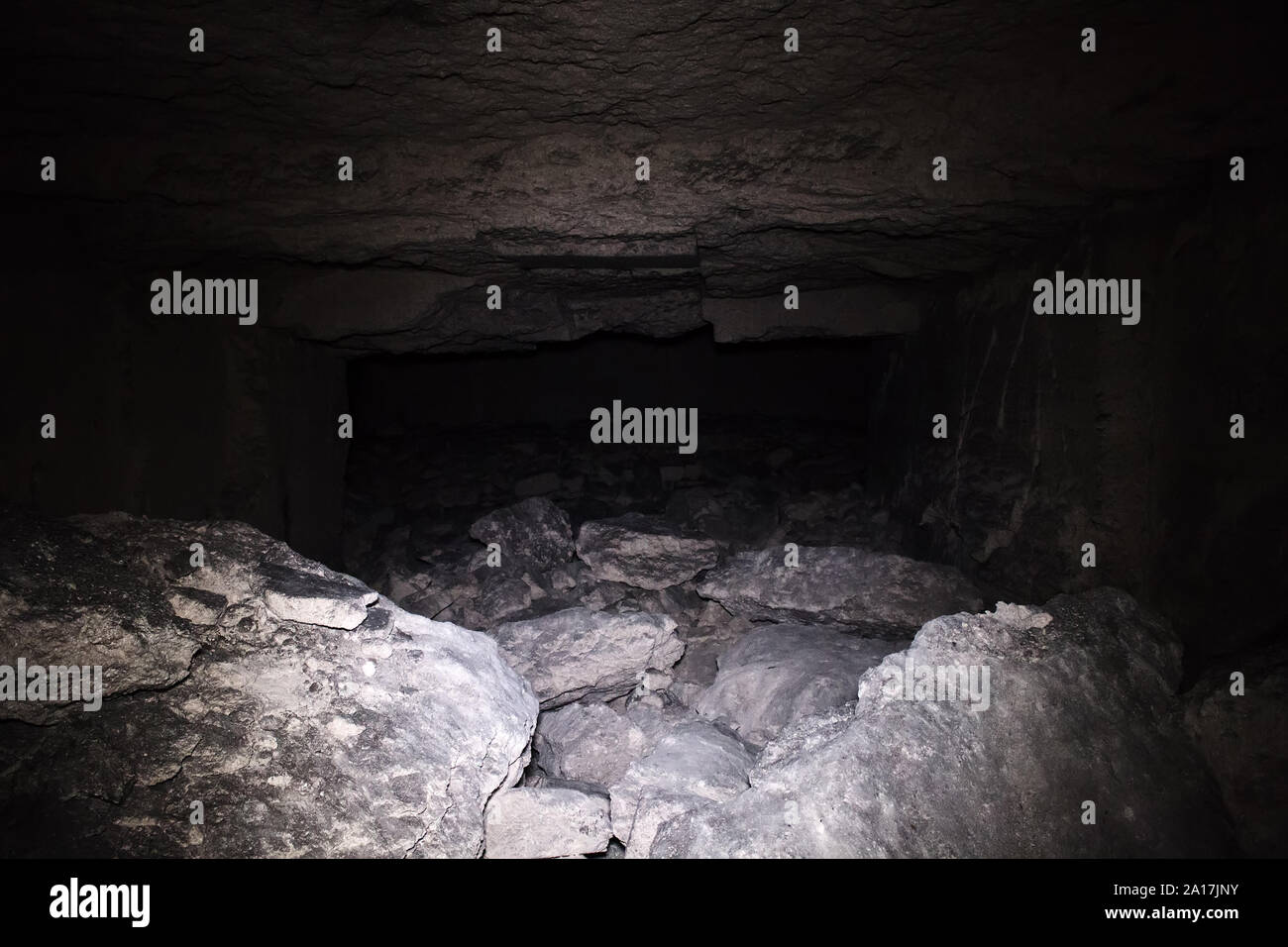 Old underground passage, dungeon, catacombs lined with stones and slabs ...