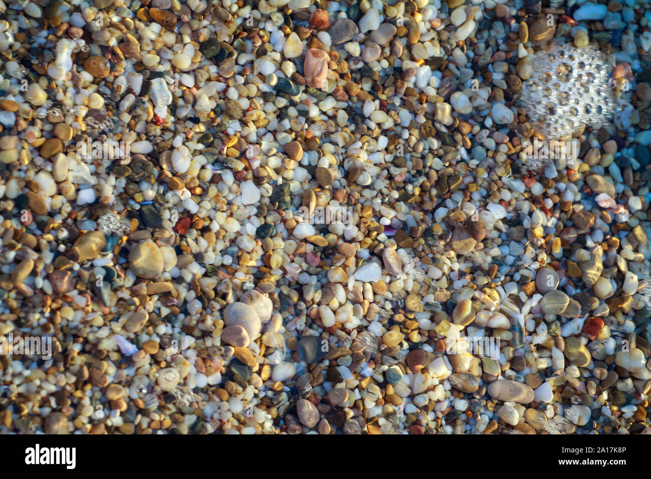 sea pebbles colored granite on the beach background stones. The shore ...